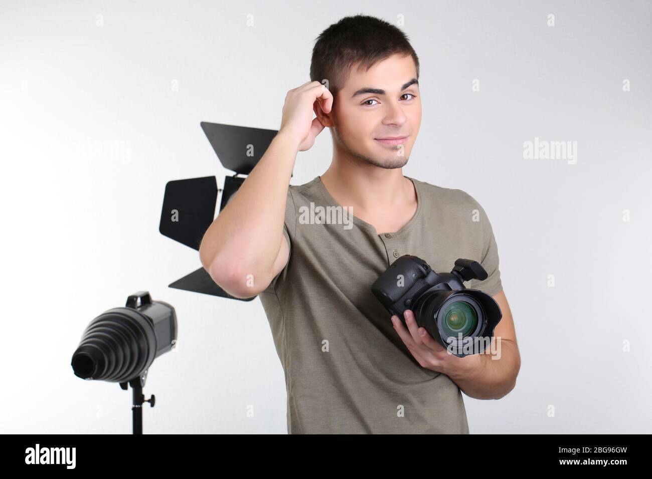 Handsome photographer with camera, on photo studio background Stock ...