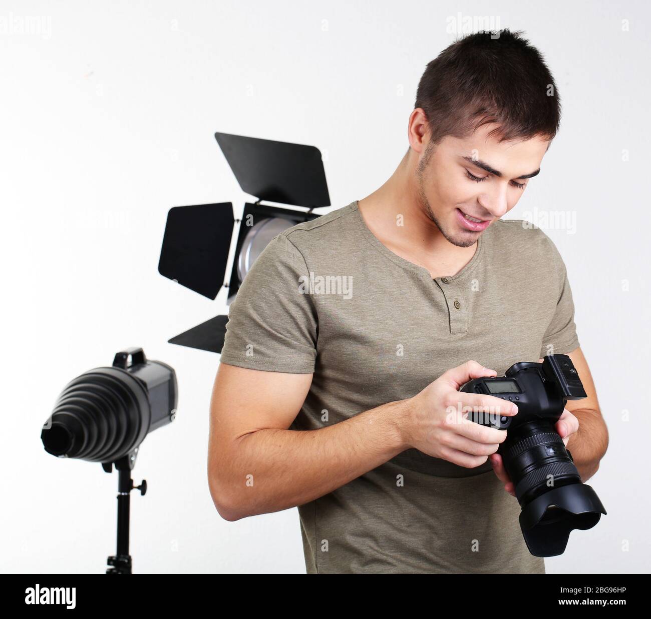 Handsome photographer with camera, on photo studio background Stock ...