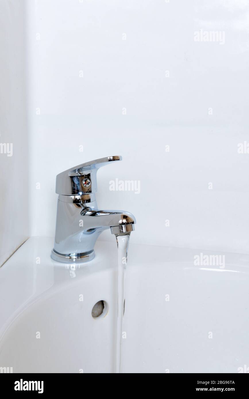 Close-up of human hands being washed under faucet in bathroom, isolated ...