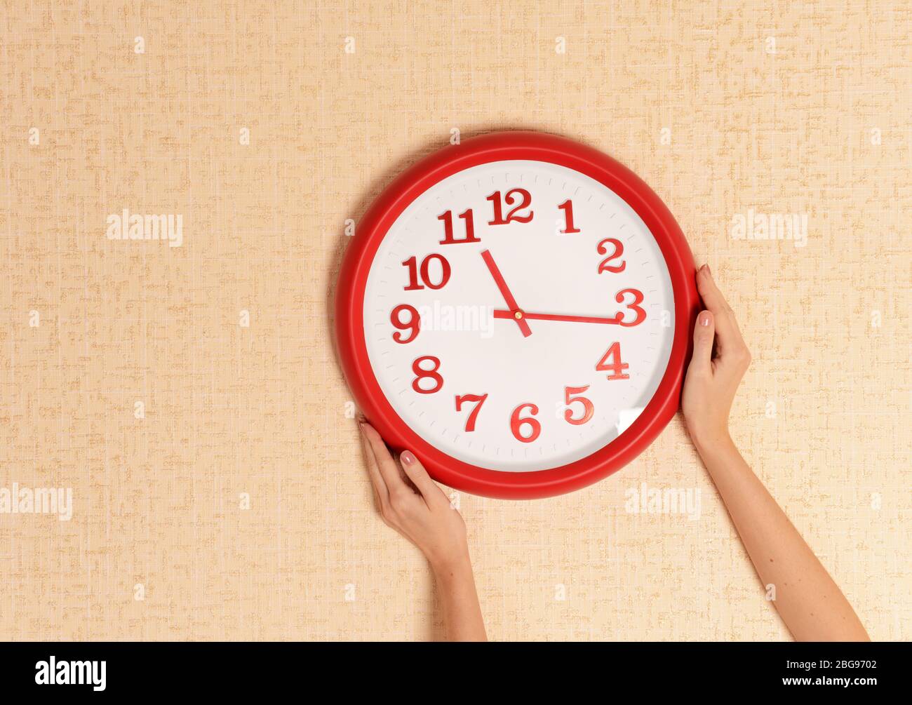 Clock on wall background Stock Photo - Alamy