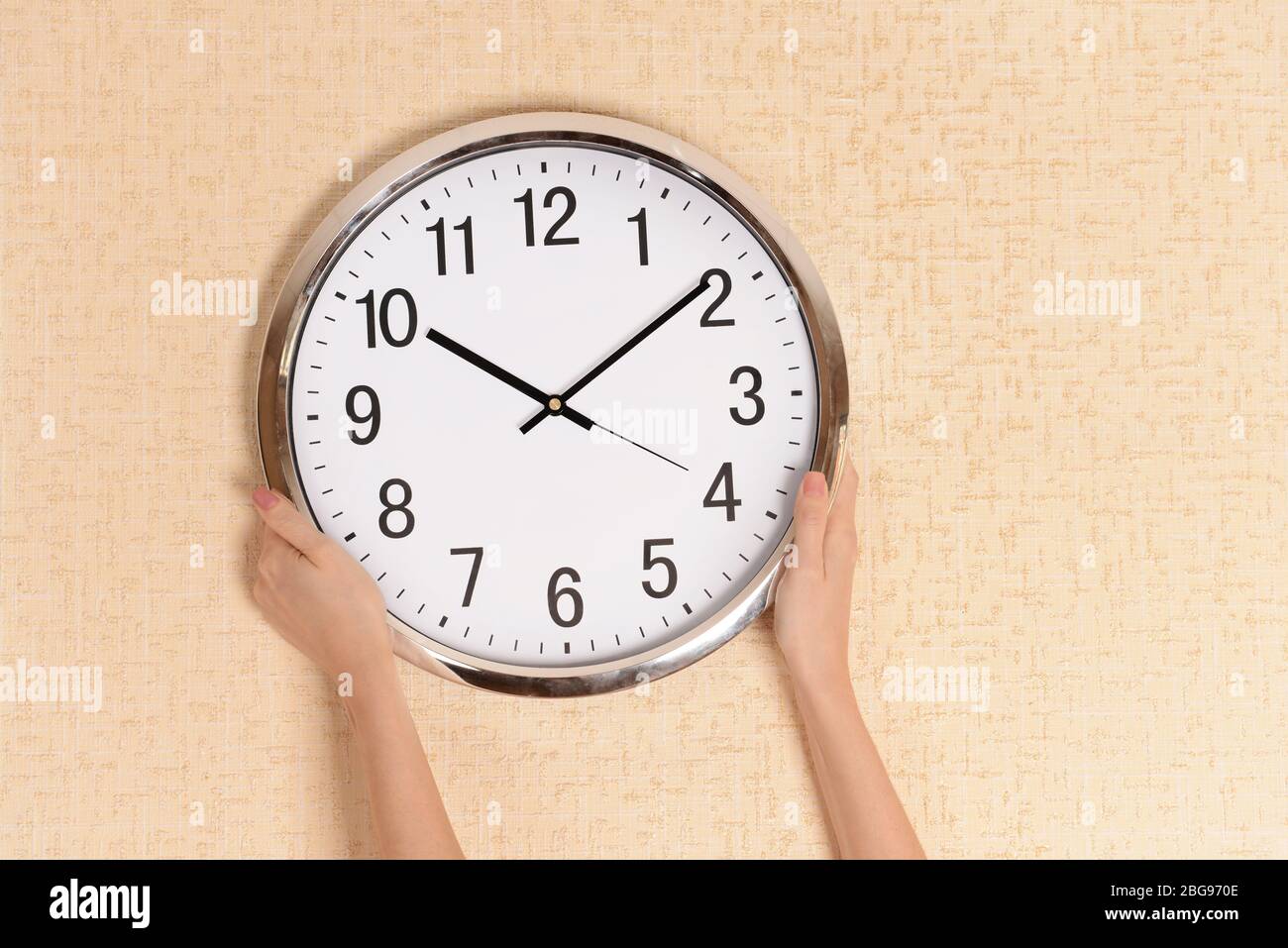 Clock on wall background Stock Photo - Alamy