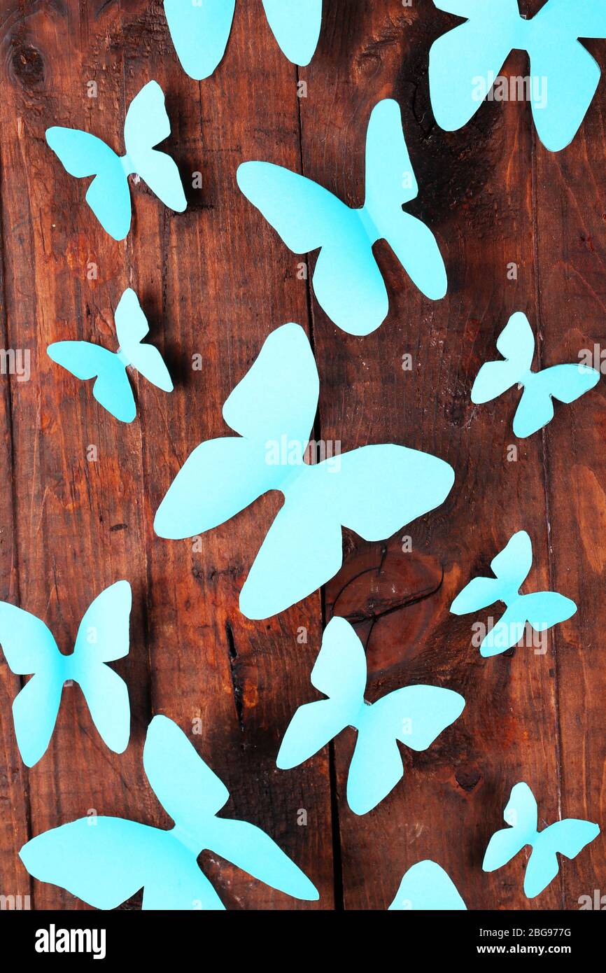Paper blue butterflies on wooden board background Stock Photo - Alamy