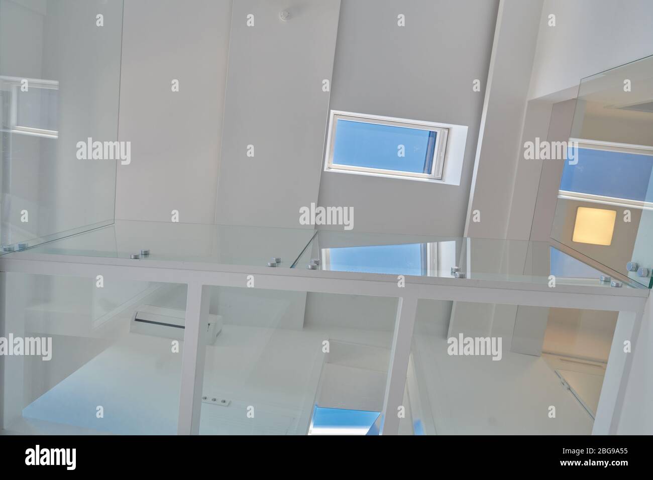 Automatic remote White skylight roof windows in a loft with white walls ...