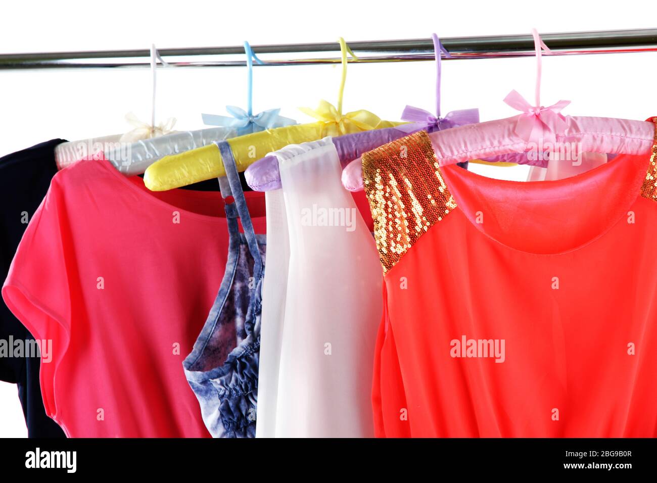Beautiful dresses hanging on hangers isolated on white Stock Photo - Alamy