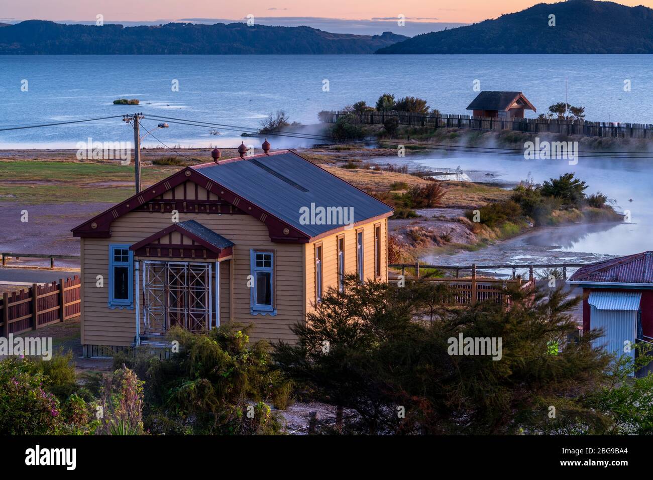 Steam rises from hot water springs and vents at Ohinemutu Maori Village ...