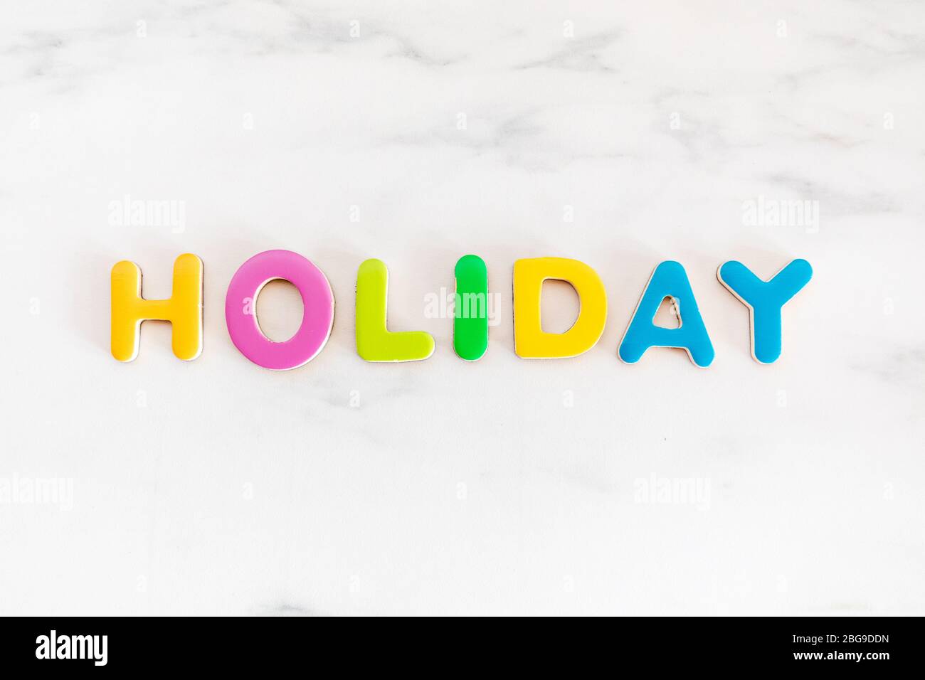 holiday word written with colorful letters on marble stone background ...