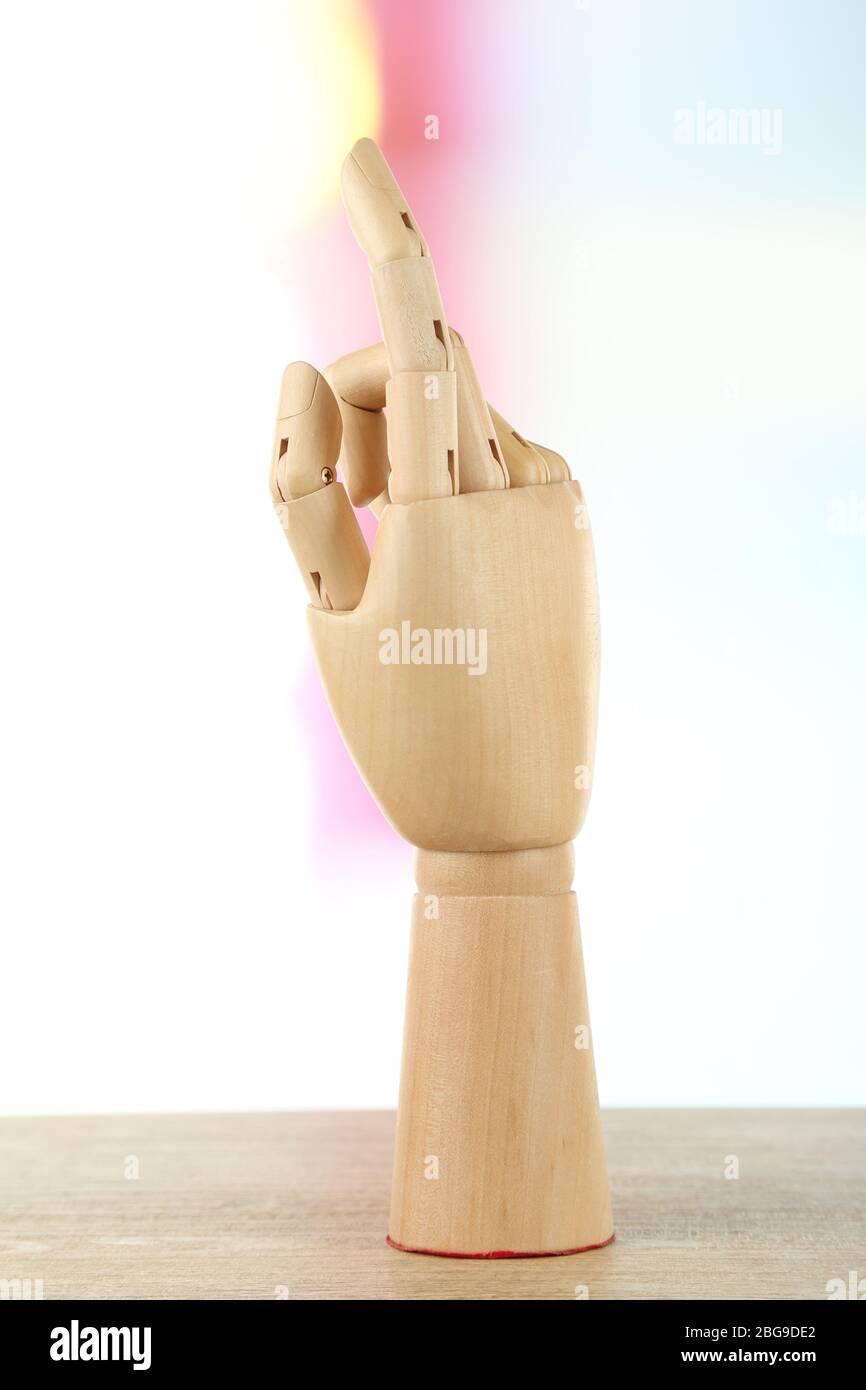 Wooden hand on light background Stock Photo - Alamy