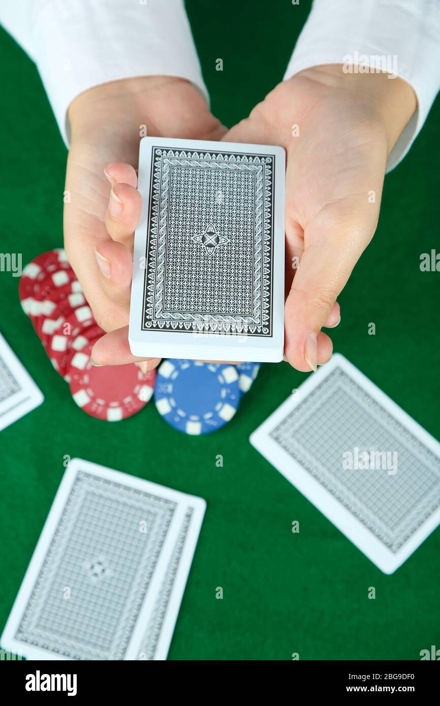 Playing cards in hands close up Stock Photo - Alamy