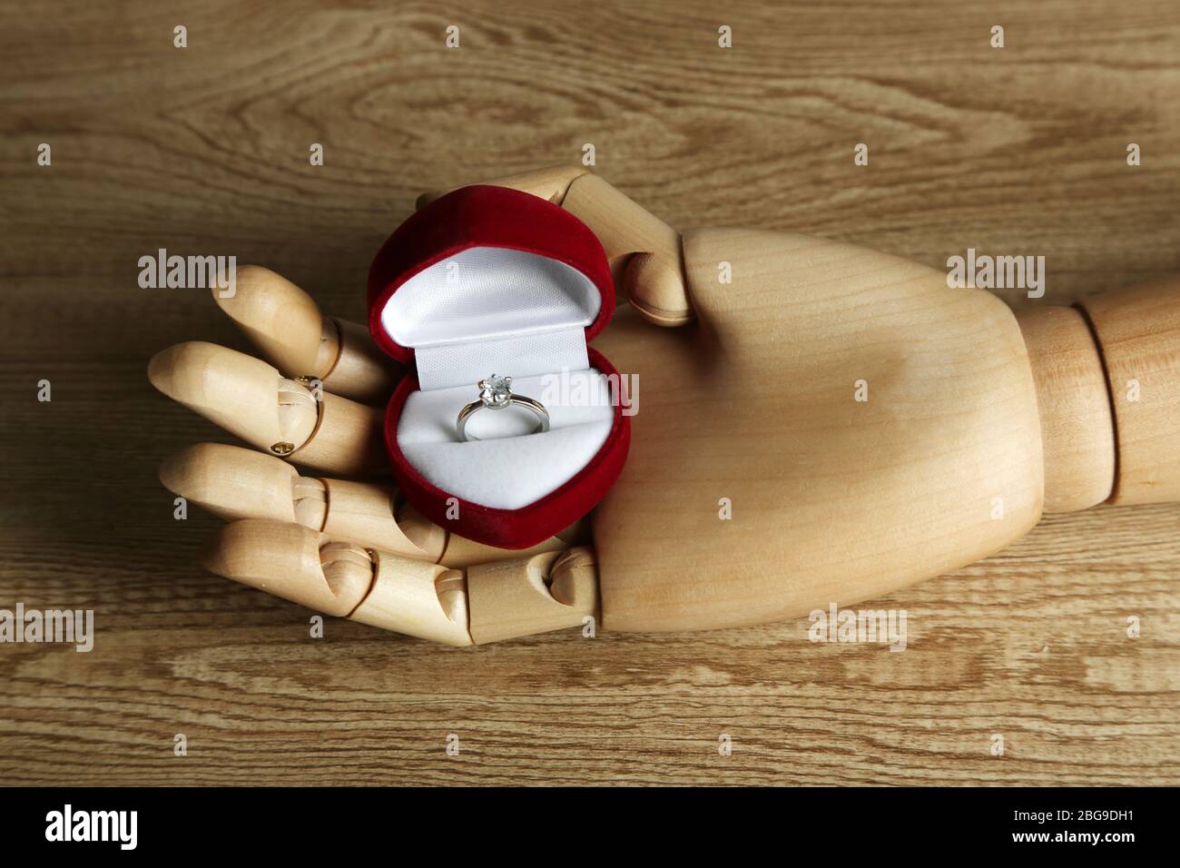 Ring in wooden hand isolated on white Stock Photo - Alamy