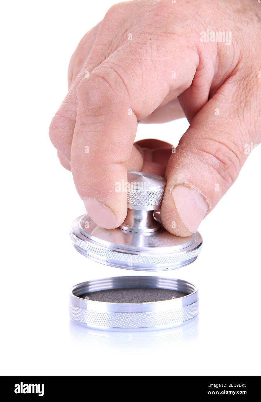 Hand with metal stamp, isolated on white Stock Photo - Alamy