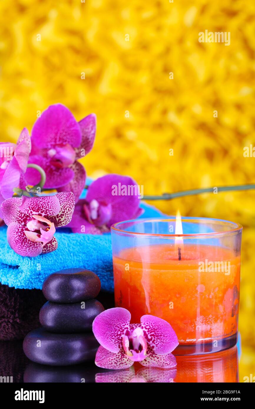 Beautiful spa setting with orchid on yellow background Stock Photo - Alamy
