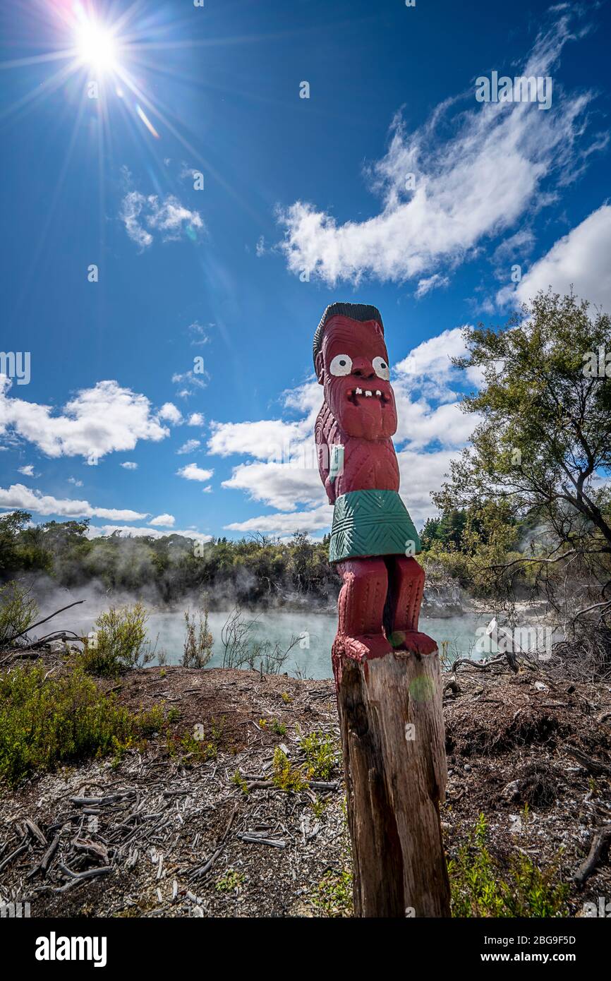 Tiki standing near geothermal hot spring, Whakarewarewa Valley, Rotorua ...