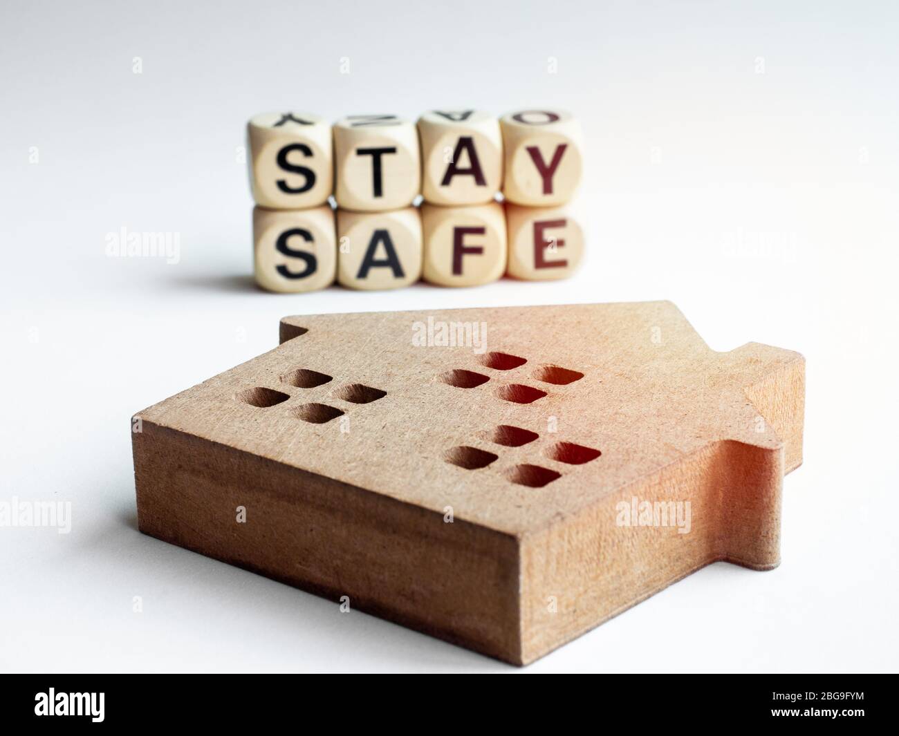 Stay safe concept. Word "Stay Safe" with wooden house isolated on white ...