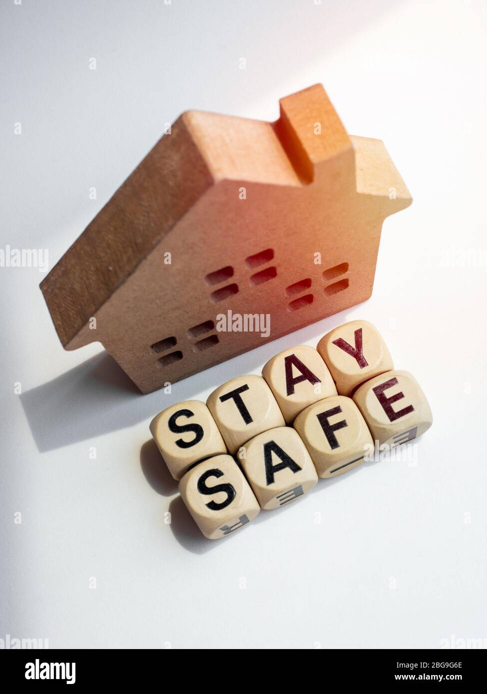 Stay safe concept. Word "Stay Safe" with wooden house isolated on white ...