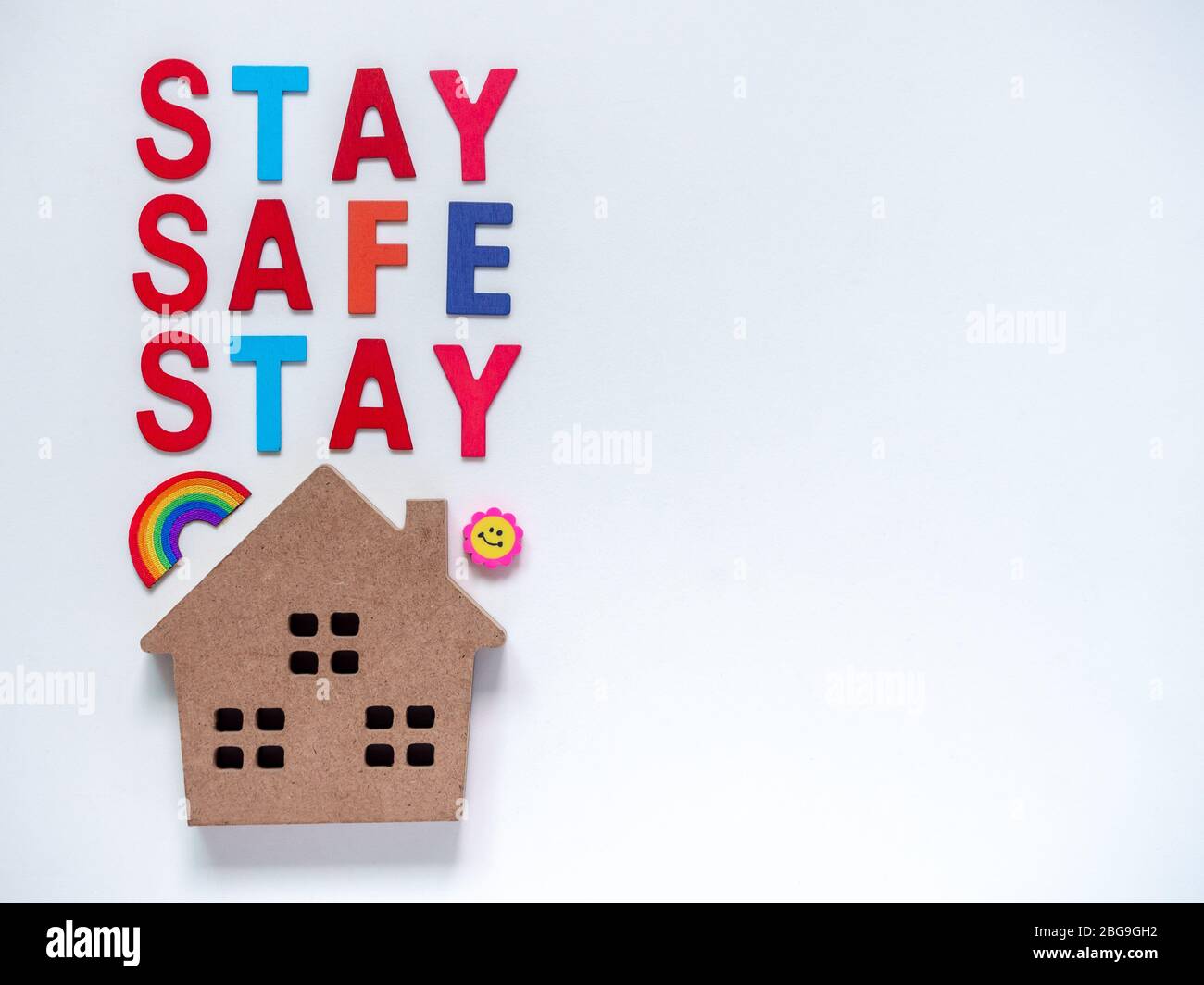Stay safe concept. Colorful word "Stay Safe" with wooden home isolated ...
