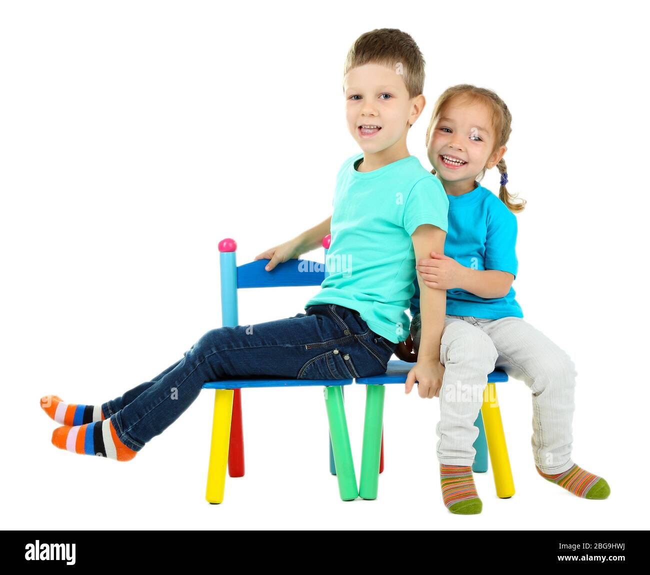 Little children playing on chairs isolated on white Stock Photo - Alamy
