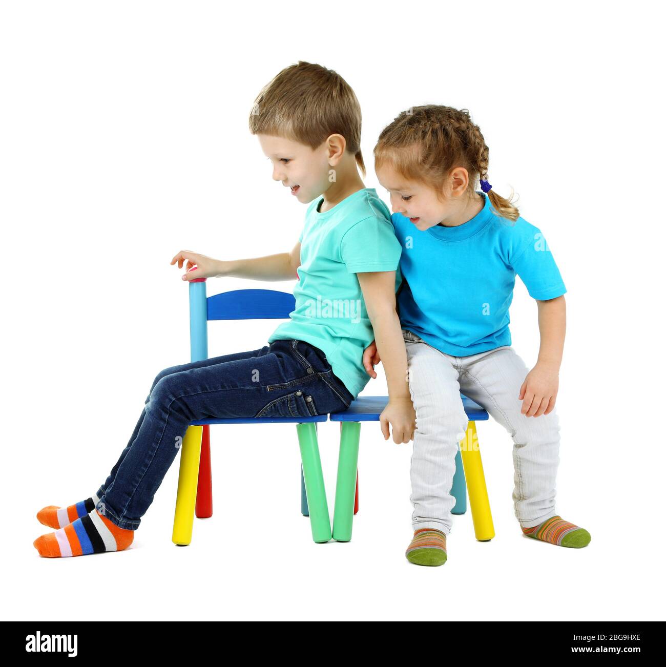 Little children playing on chairs isolated on white Stock Photo - Alamy