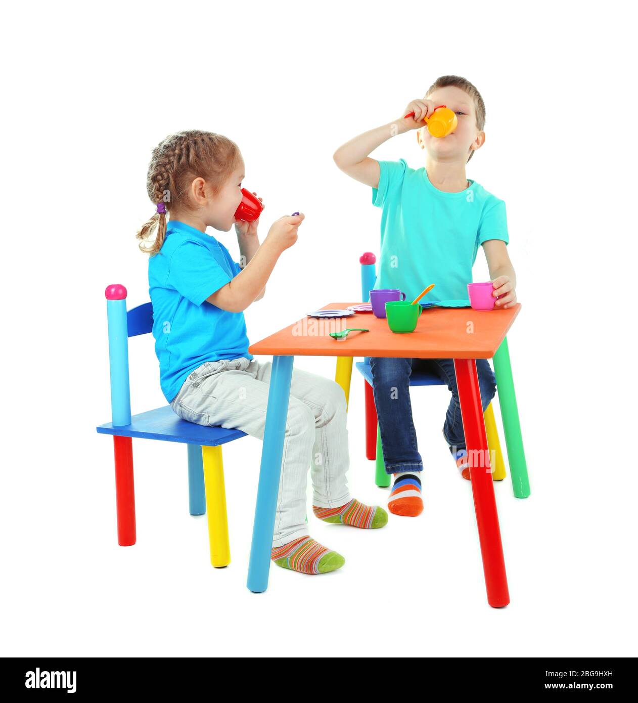 Little children playing with colorful tableware isolated on white Stock ...