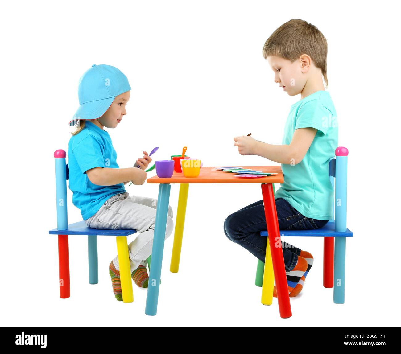 Little children playing with colorful tableware isolated on white Stock ...