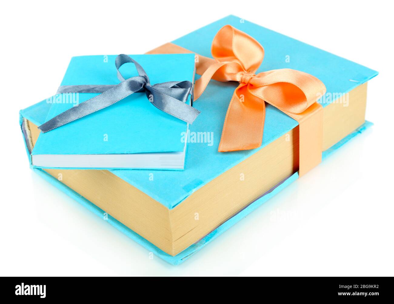 Books wrapped with color ribbons, isolated on white Stock Photo - Alamy