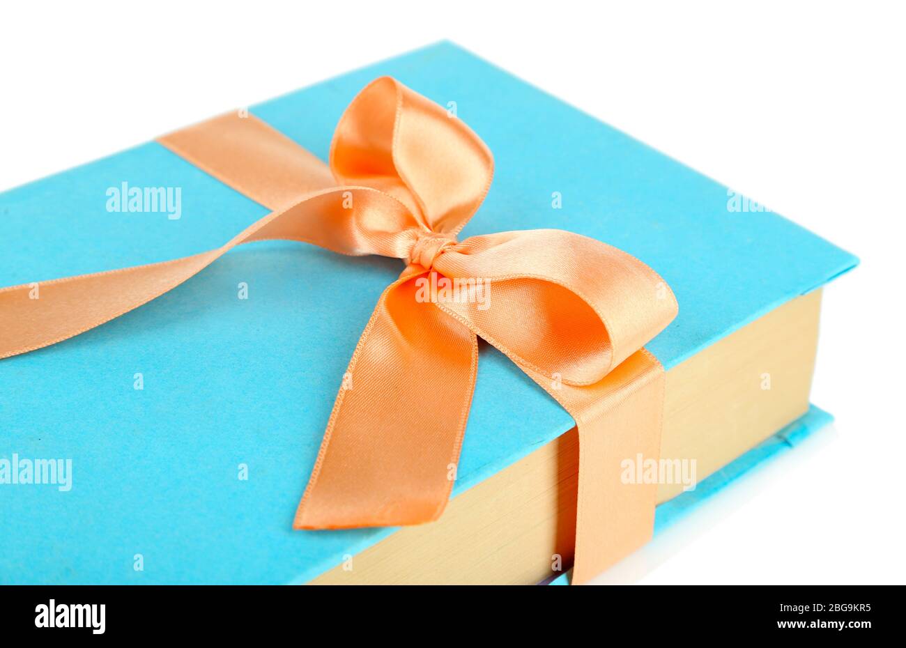 Book wrapped with color ribbon, isolated on white Stock Photo - Alamy