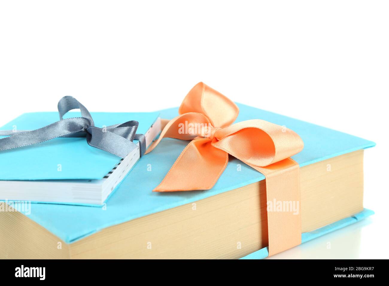 Books wrapped with color ribbons, isolated on white Stock Photo - Alamy