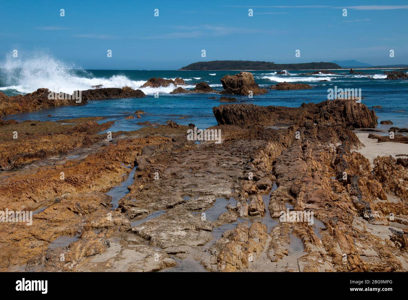 Tomakin Australia, view of rock outcrop looking out to sea with island ...