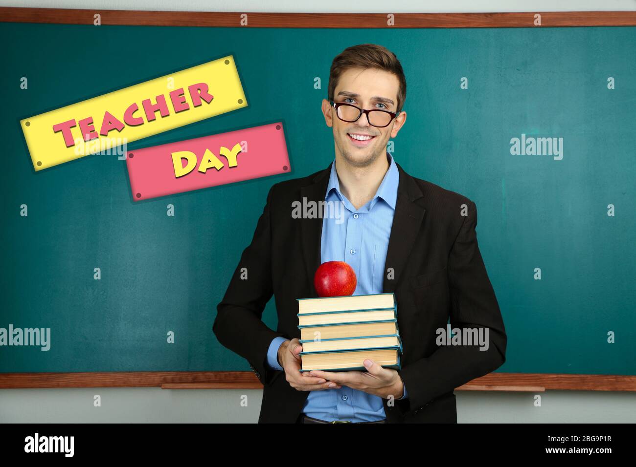 Young teacher near chalkboard in school classroom Stock Photo - Alamy