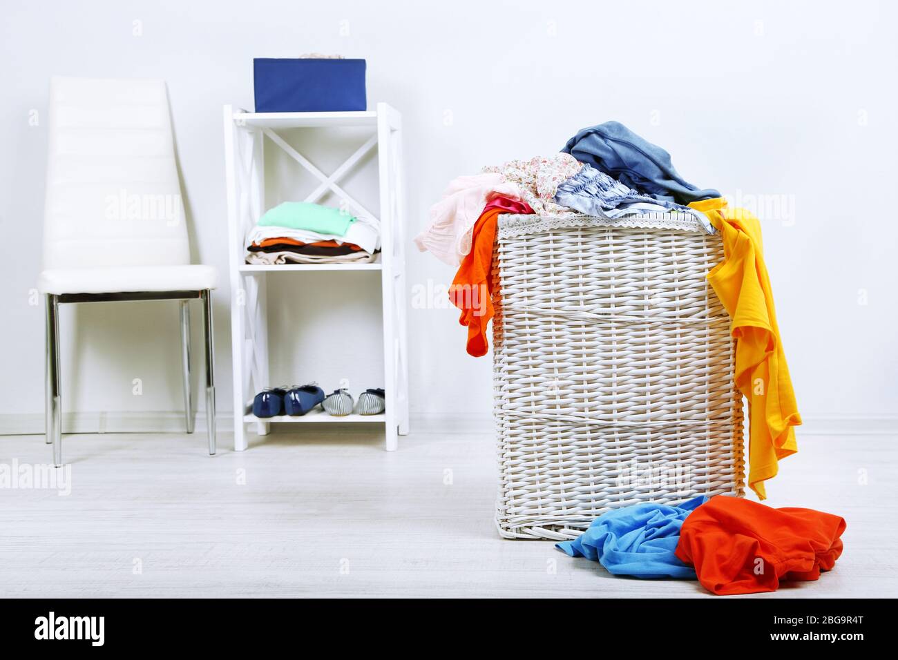 Full laundry basket on wooden floor on home interior background Stock ...