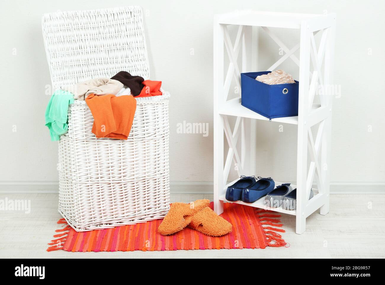 Full laundry basket on wooden floor on home interior background Stock ...