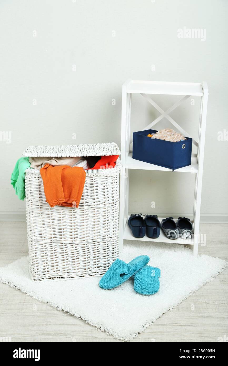 Full laundry basket on wooden floor on home interior background Stock ...