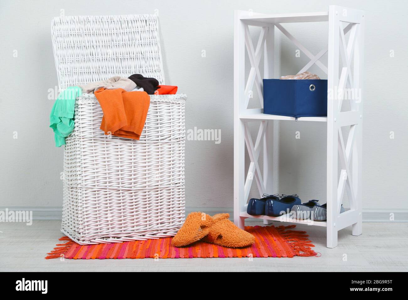Full laundry basket on wooden floor on home interior background Stock ...