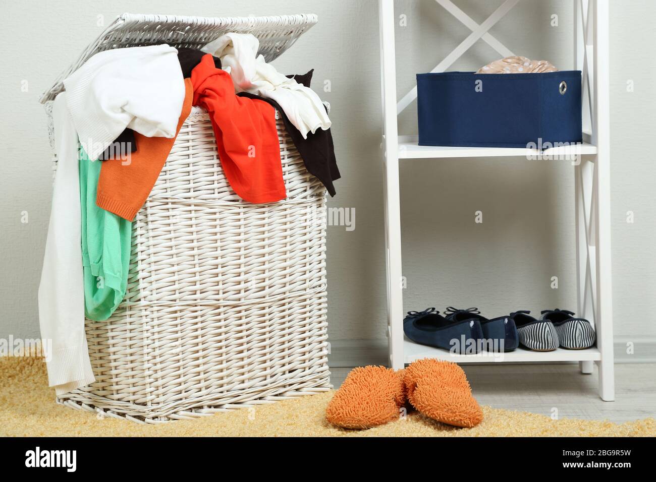 Full laundry basket on wooden floor on home interior background Stock ...