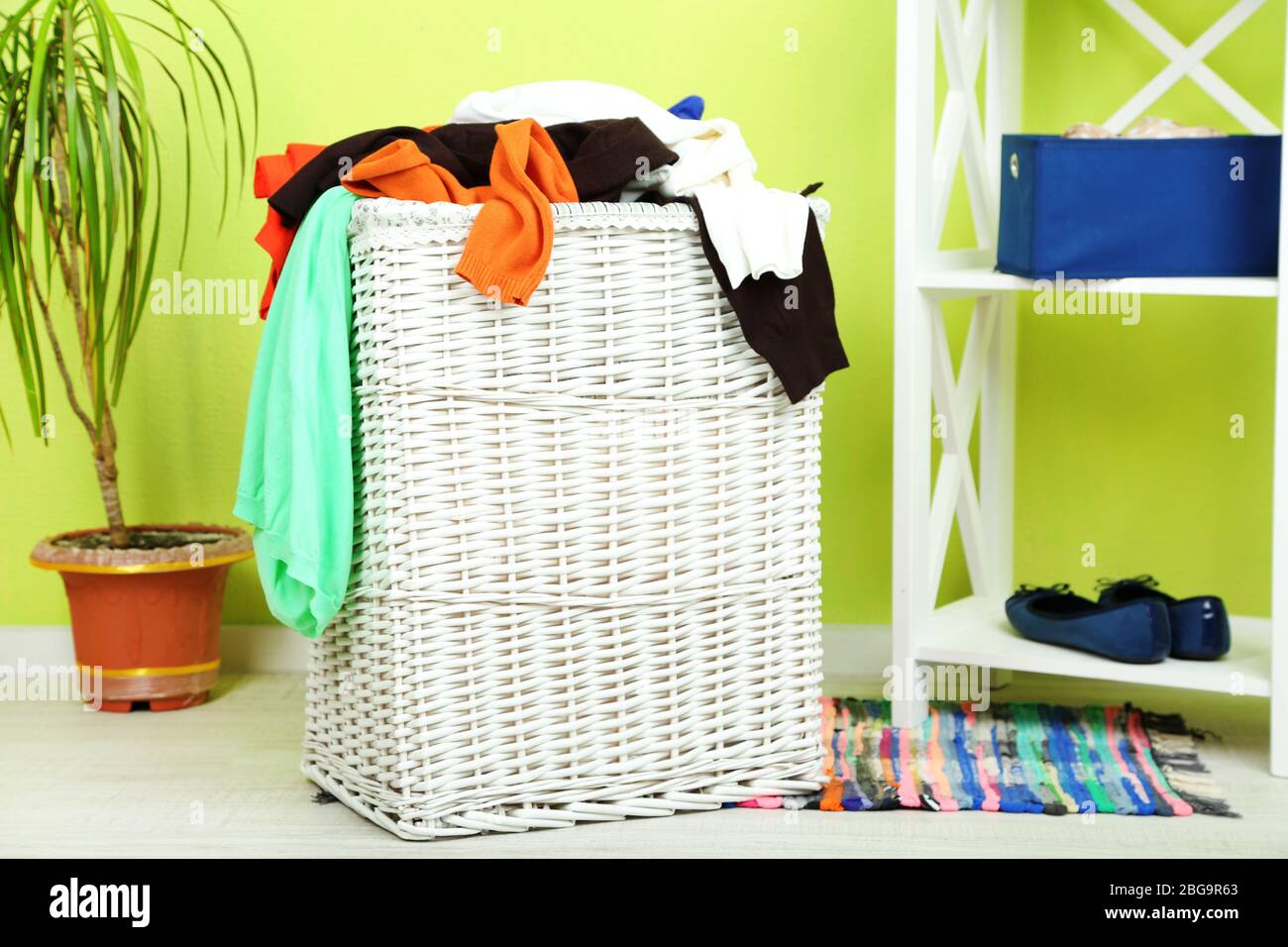 Full laundry basket on wooden floor on home interior background Stock ...