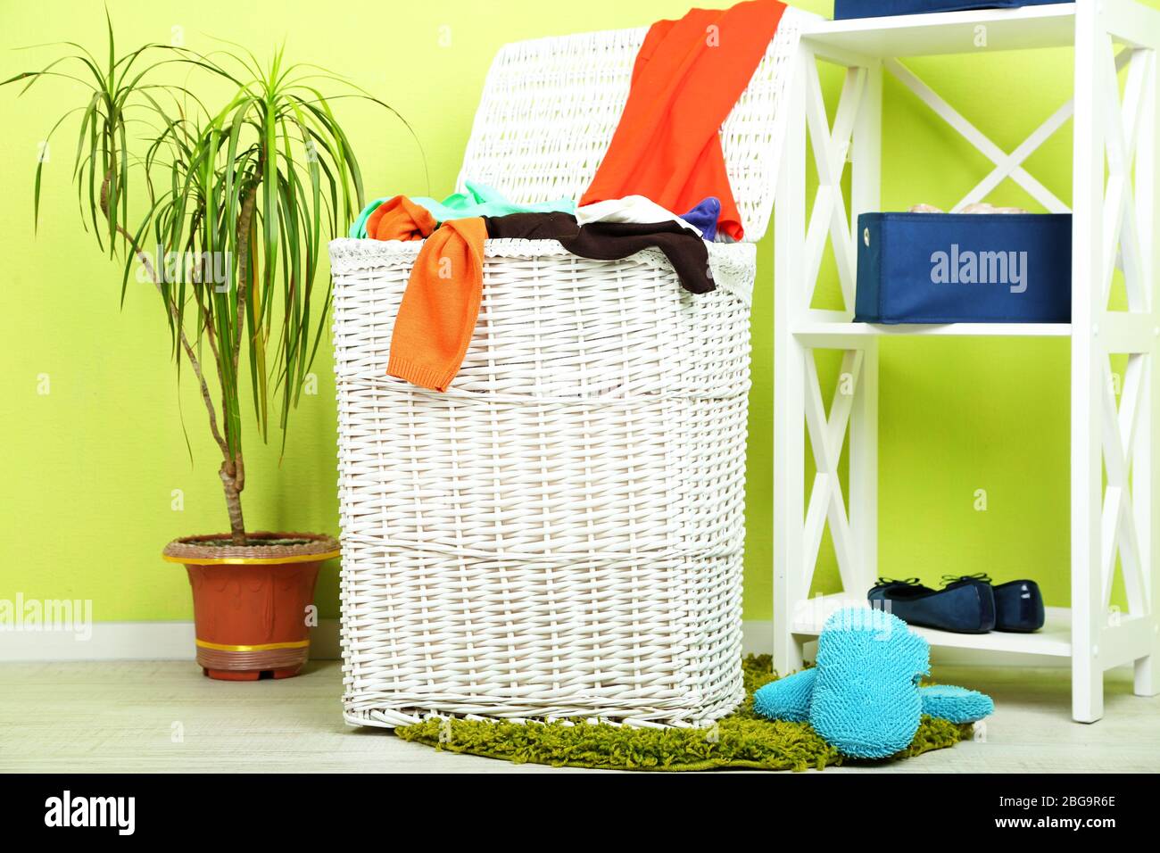Full laundry basket on wooden floor on home interior background Stock ...