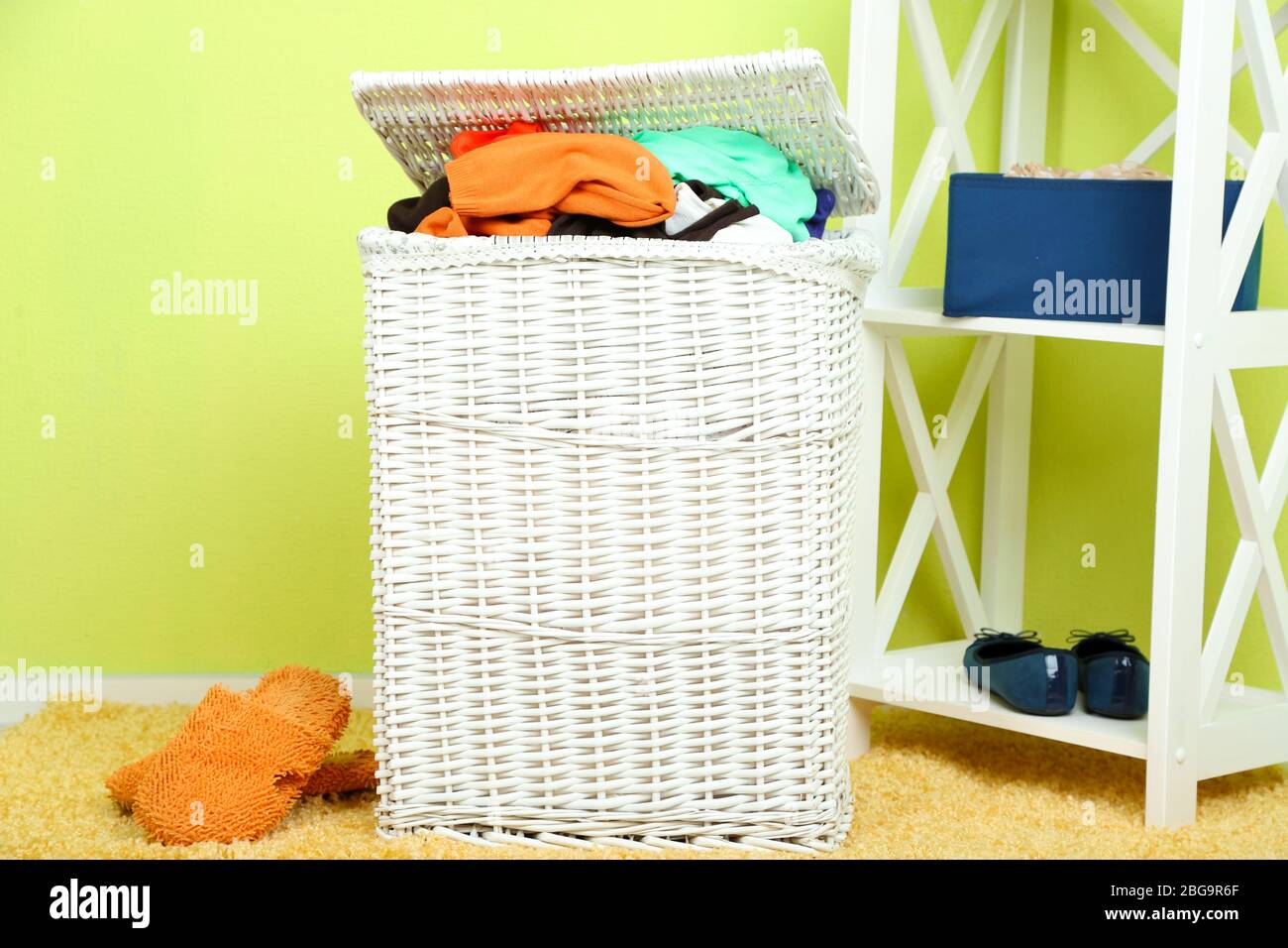 Full laundry basket on wooden floor on home interior background Stock ...