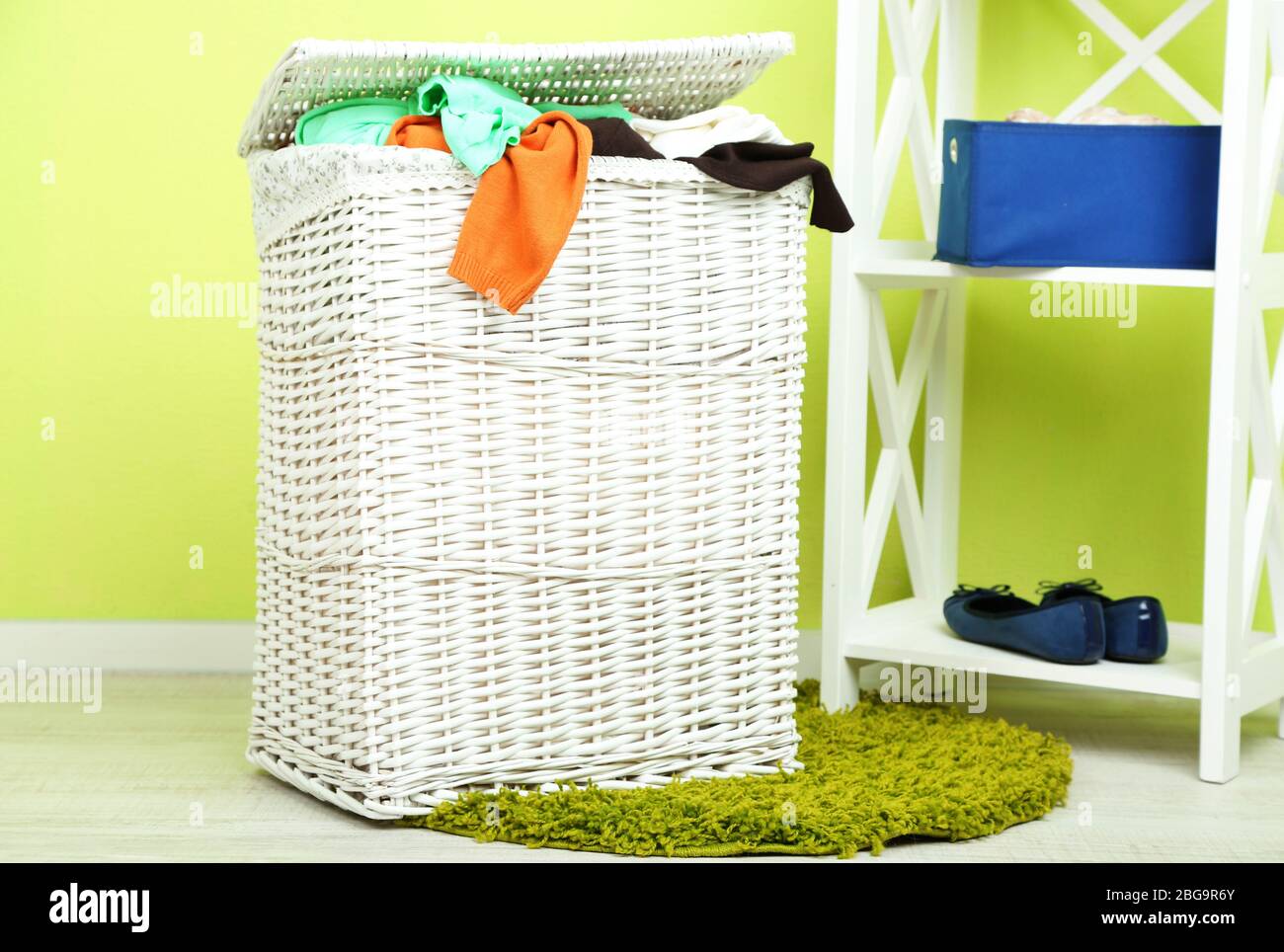 Full laundry basket on wooden floor on home interior background Stock ...