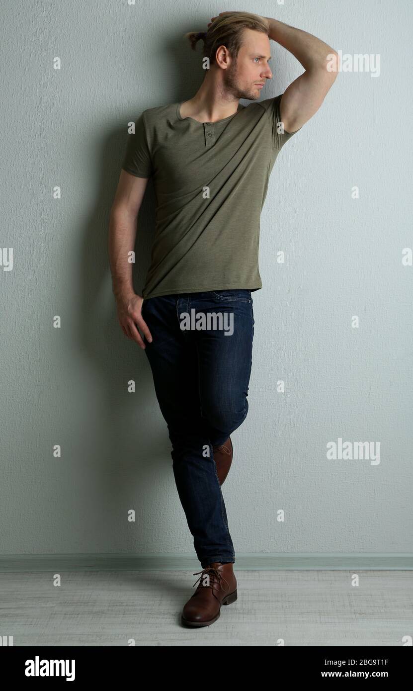 Fashion young model poses over wall with shadow Stock Photo - Alamy
