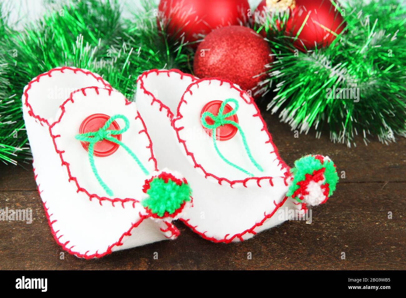 Christmas shoes with decorations on table close up Stock Photo - Alamy