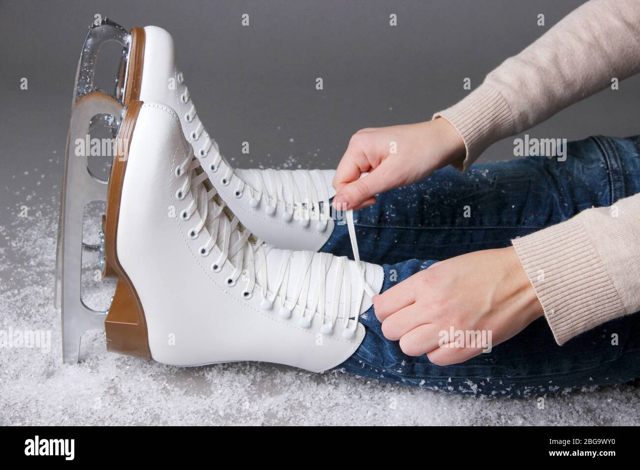Skater wearing skates on gray background Stock Photo - Alamy