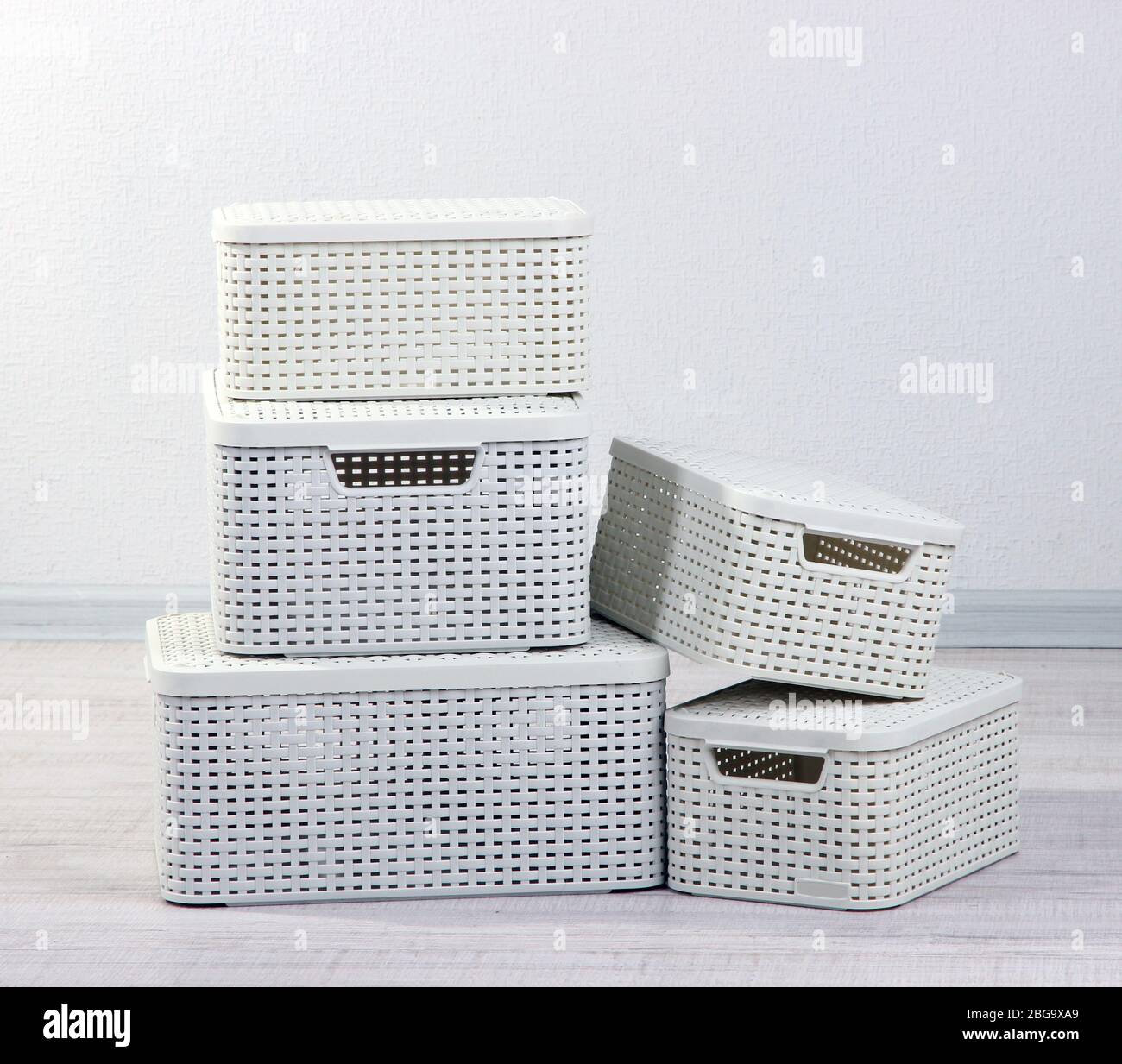 Plastic baskets for storing things in floor on room background Stock ...