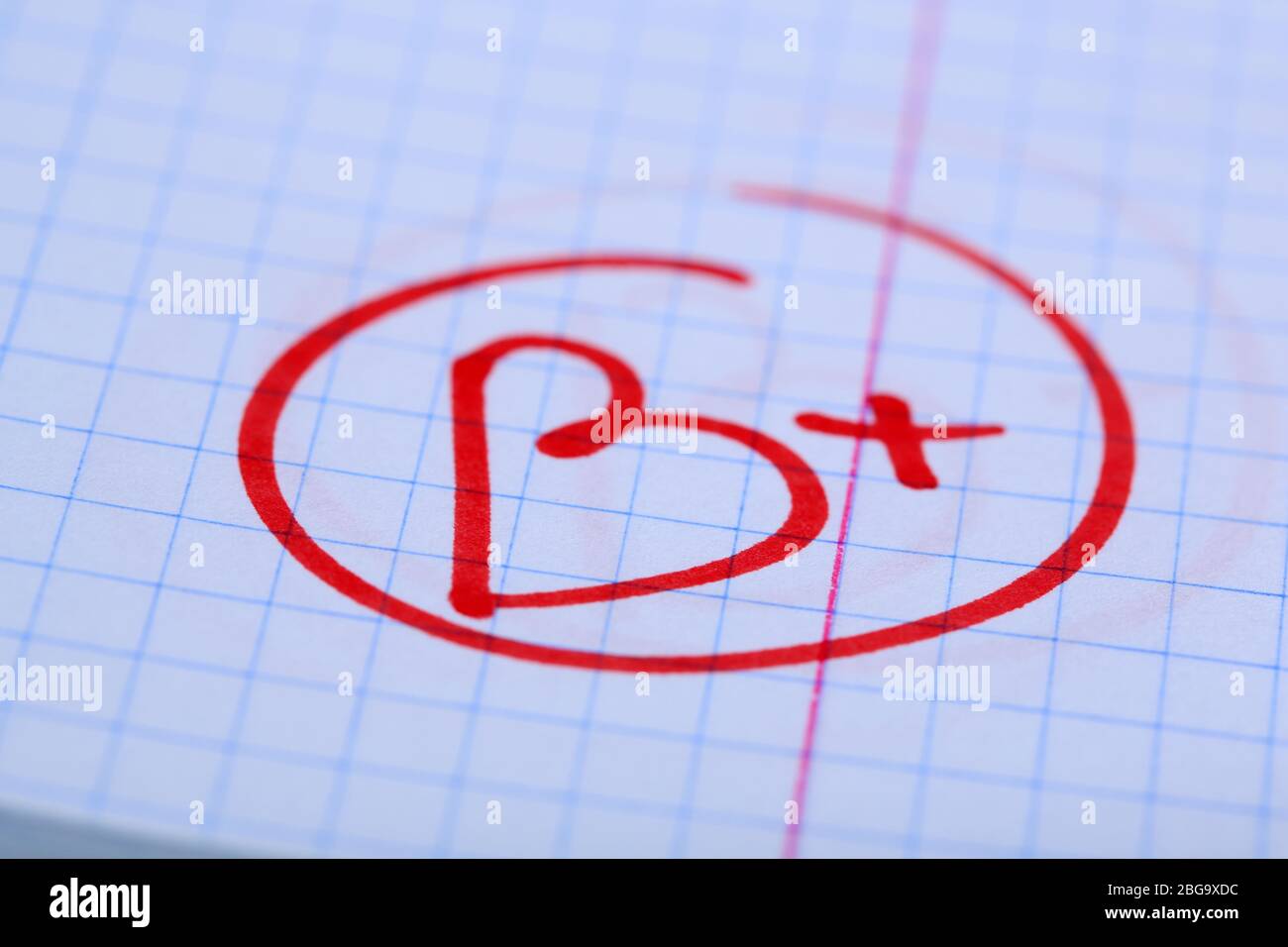 Grade B+ written on an exam paper Stock Photo - Alamy