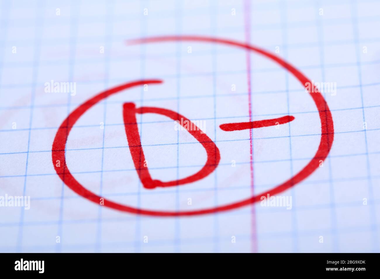 Grade D- written on an exam paper Stock Photo - Alamy