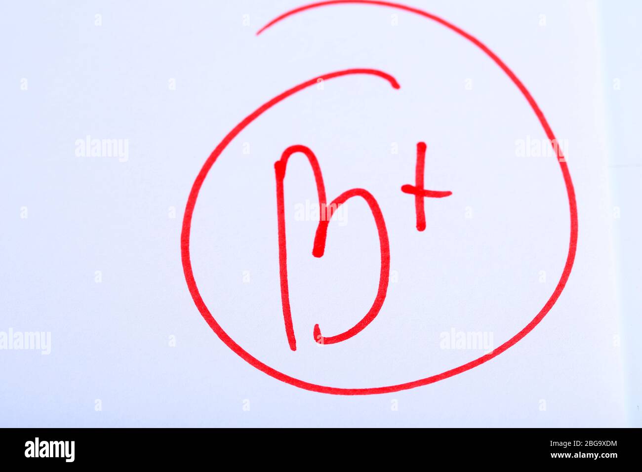 Grade B+ written on an exam paper Stock Photo - Alamy