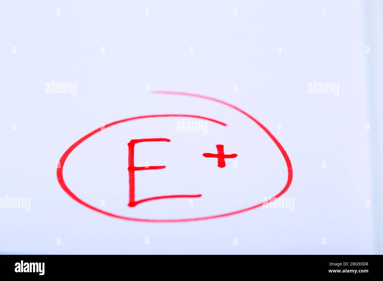 Grade E+ written on an exam paper Stock Photo - Alamy