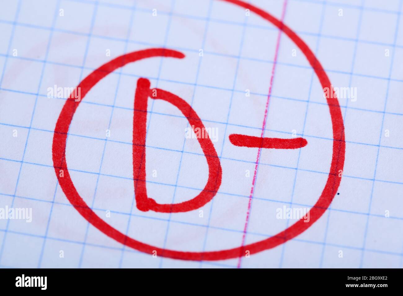 Grade D- written on an exam paper Stock Photo - Alamy