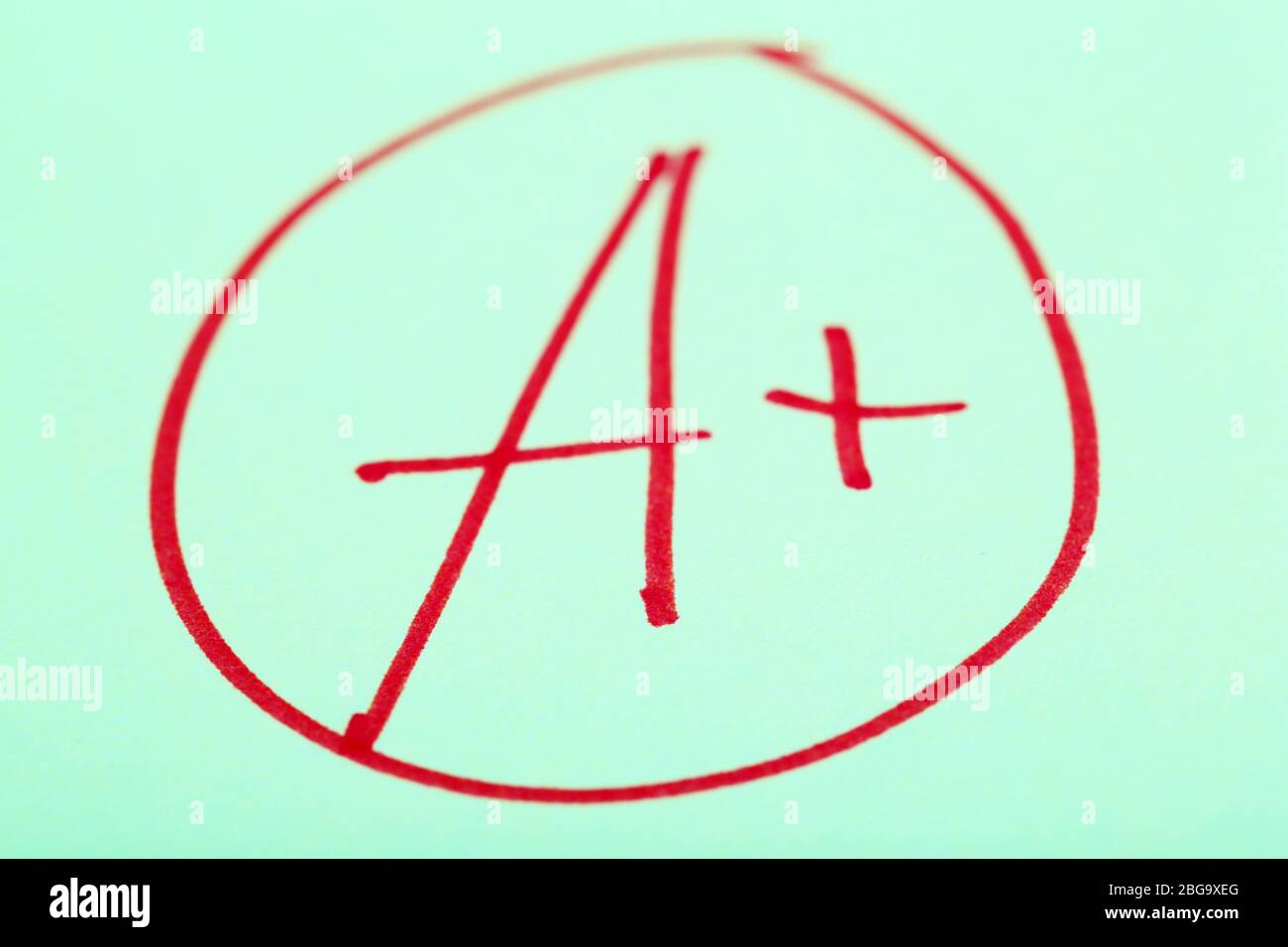 Grade A+ written on an exam paper Stock Photo - Alamy