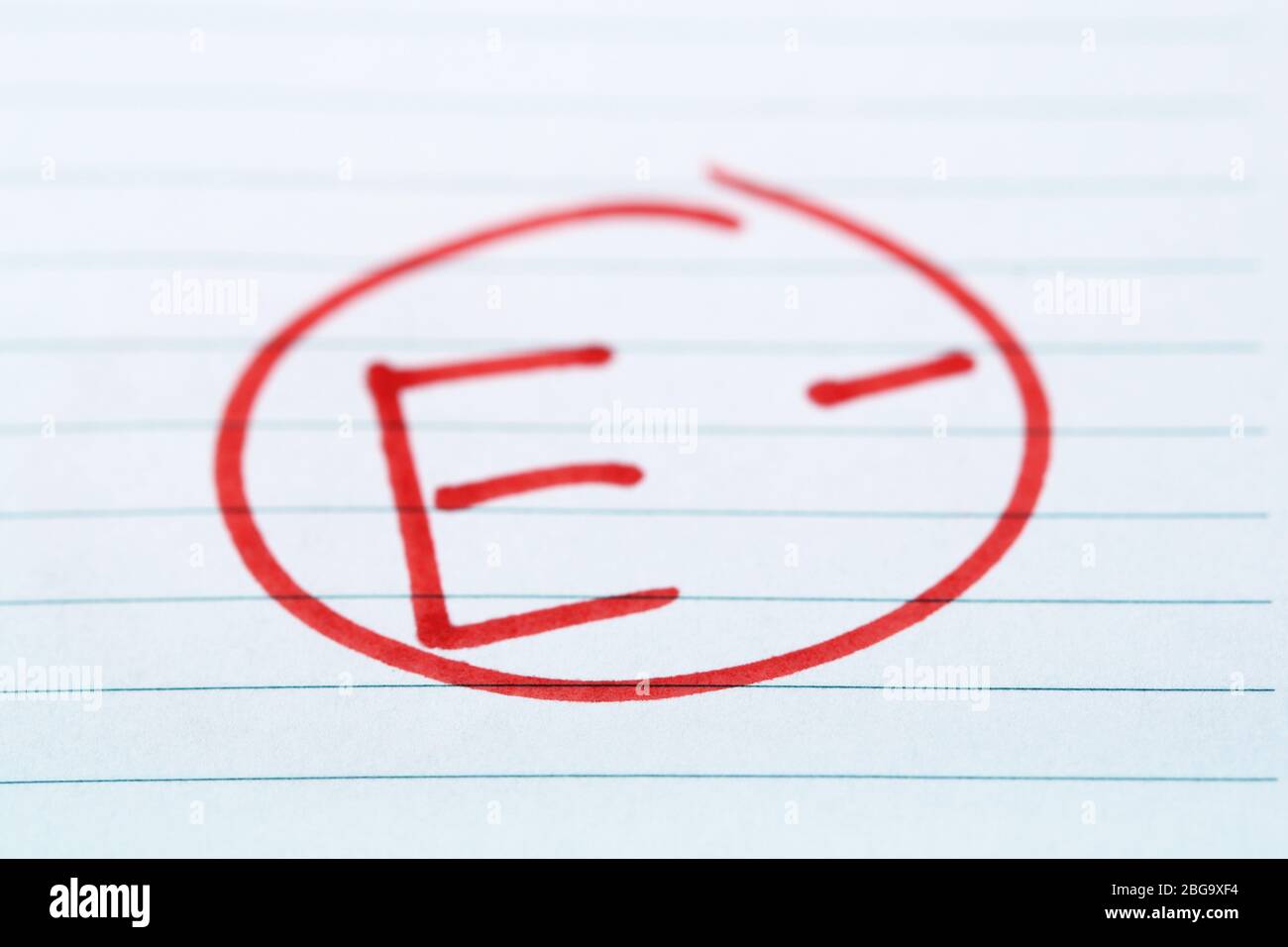 Grade E- written on an exam paper Stock Photo - Alamy