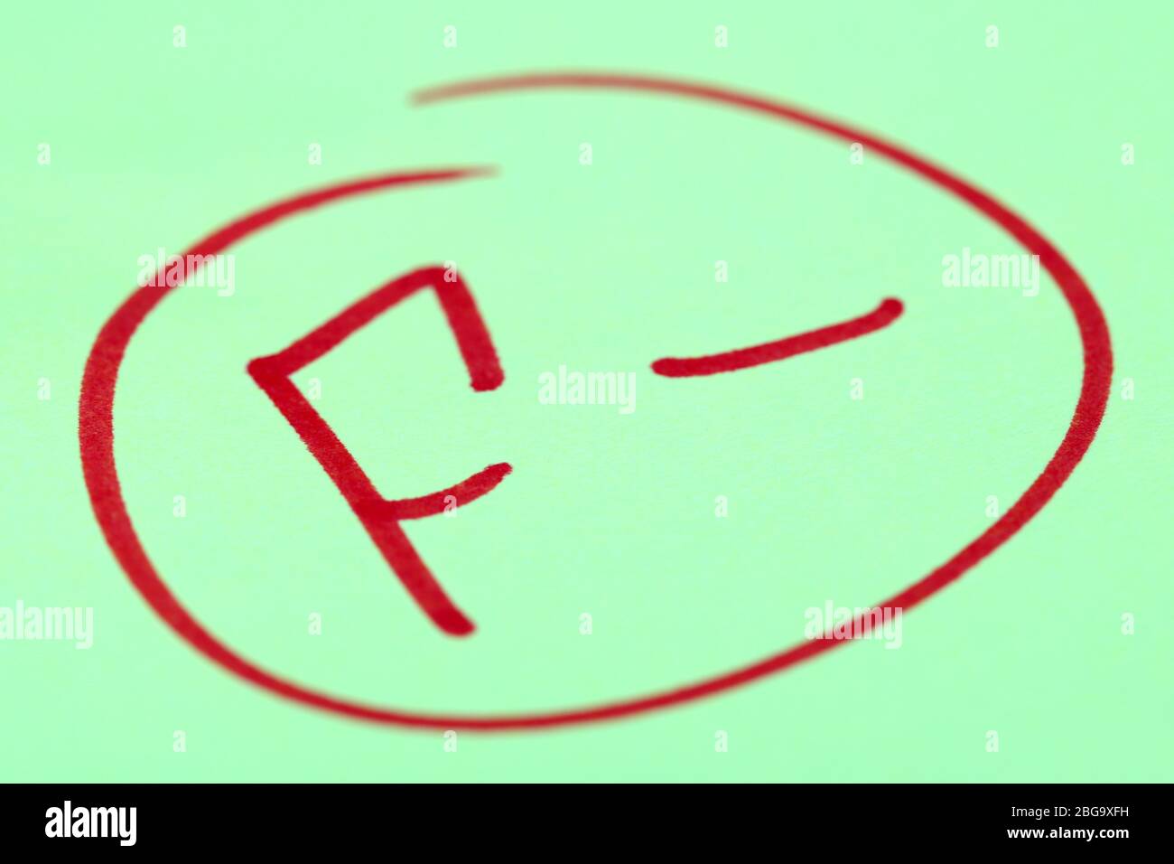 Grade F- written on an exam paper Stock Photo - Alamy
