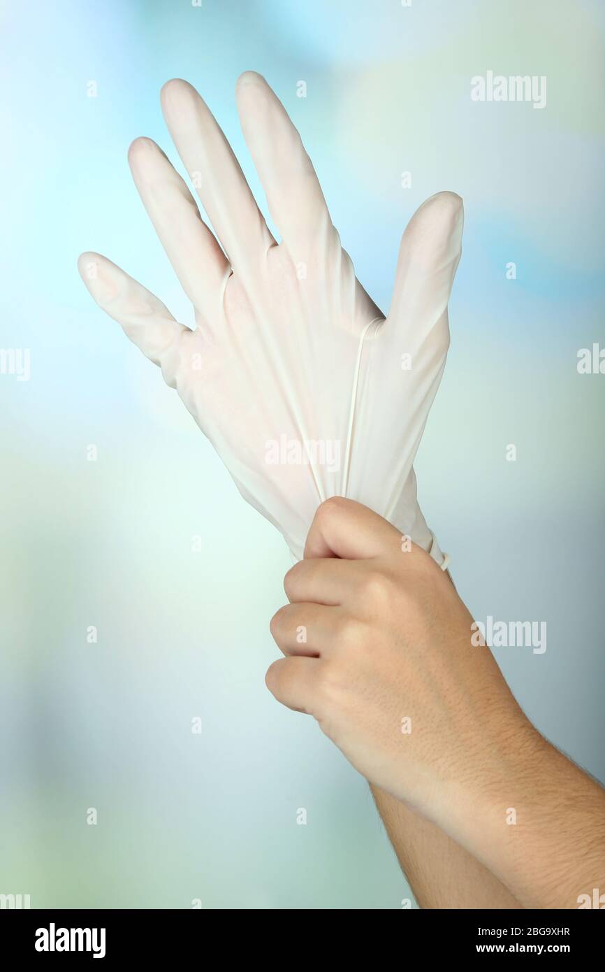 Doctor putting on glove finger hi-res stock photography and images - Alamy
